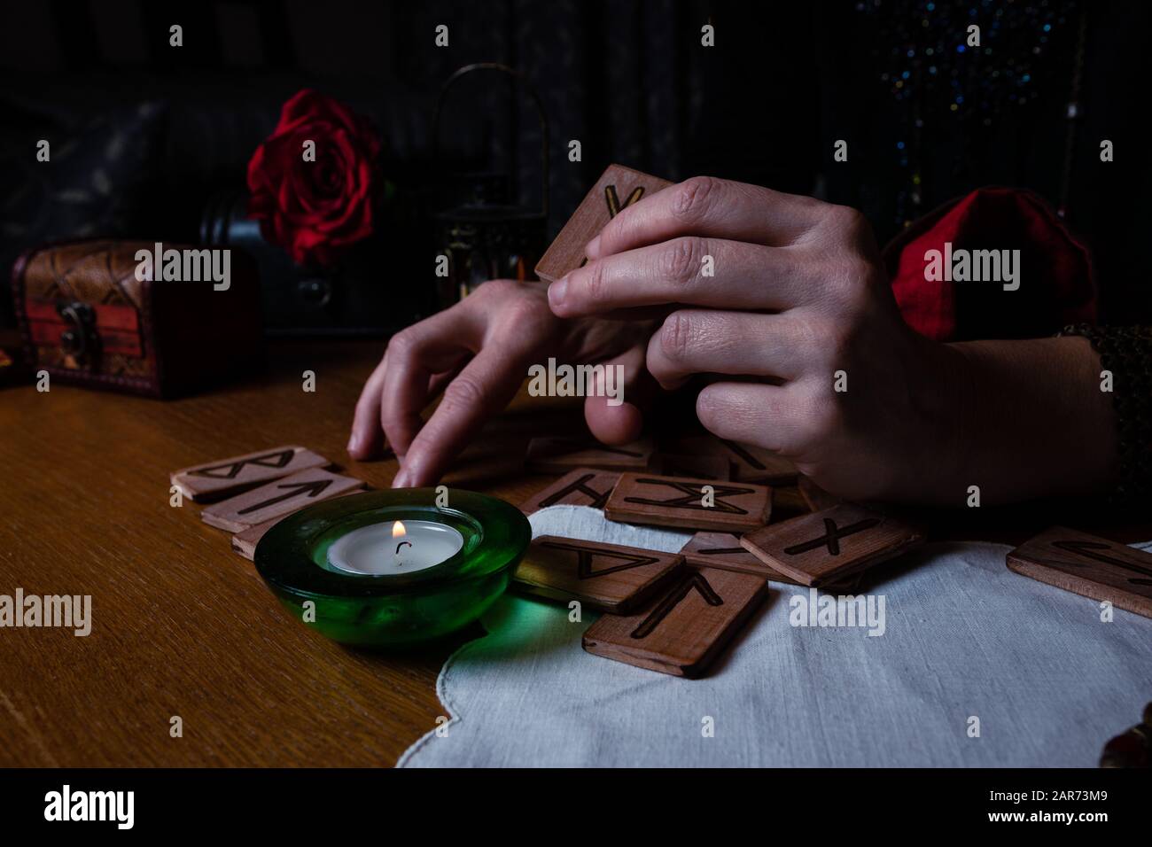 Hands of a mature woman hold runes. Fortune telling on the runes Stock ...