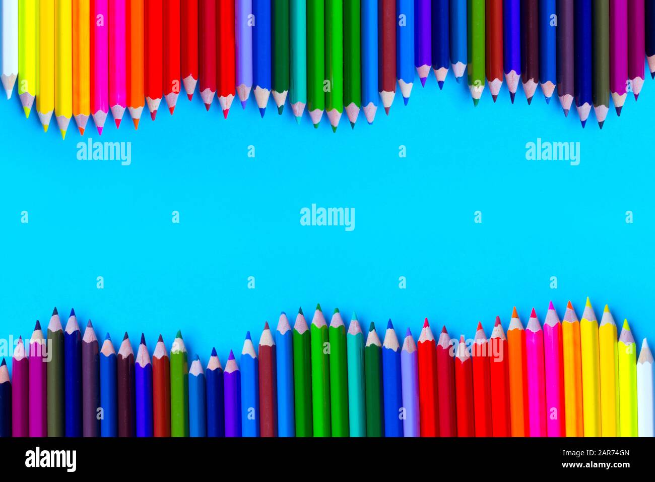 Colored pencils composition on blue background. Flat lay, layout and ...