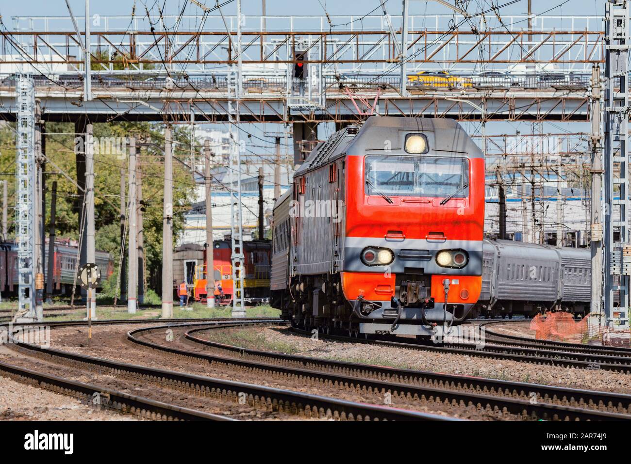 Passenger train approaches to the station Stock Photo - Alamy