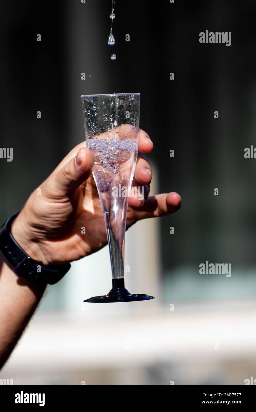 Mens hands pouring champagne into a glass, close up Stock Photo - Alamy