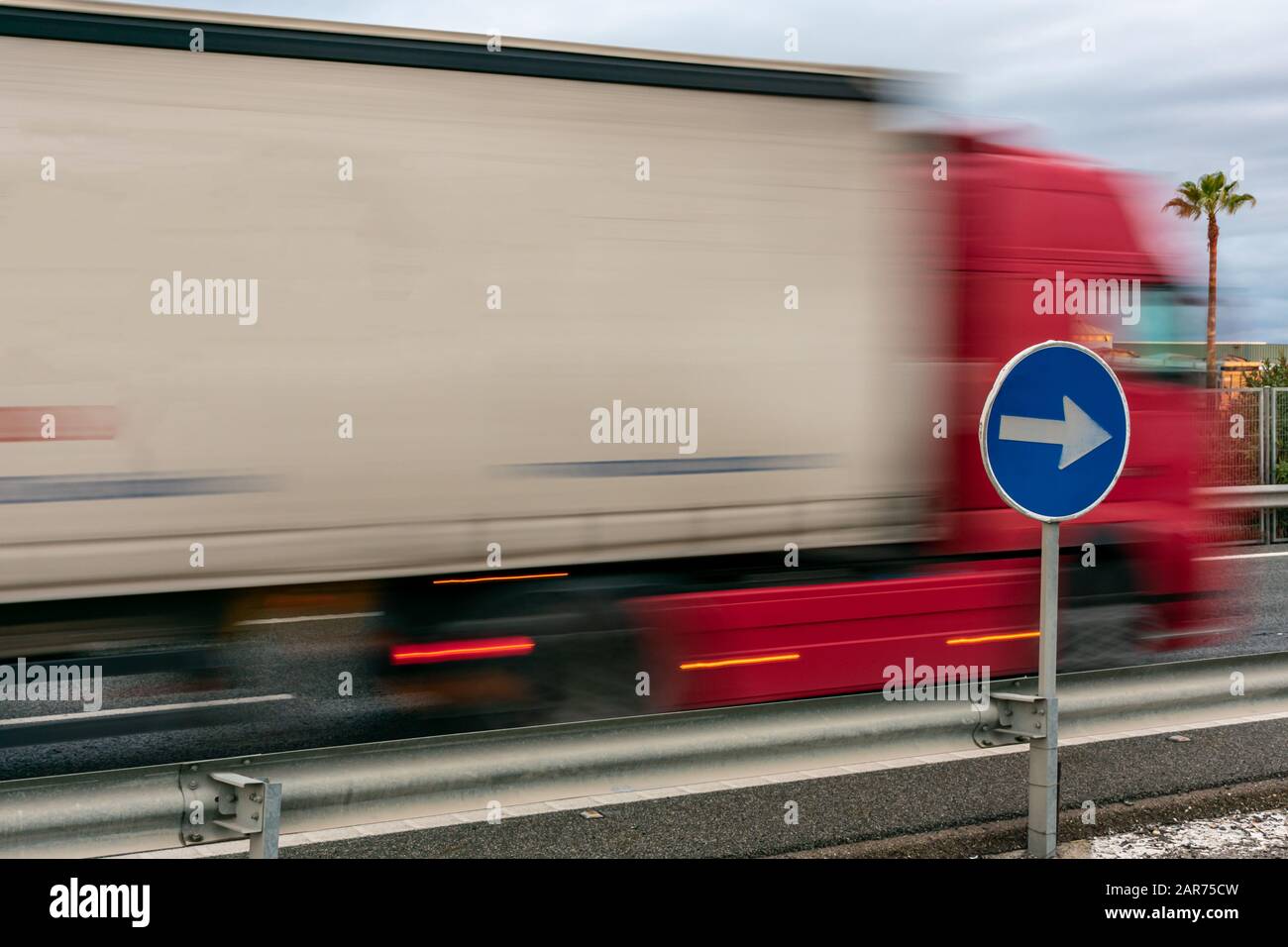 Mandatory traffic sign and truck moving in the same direction Stock ...