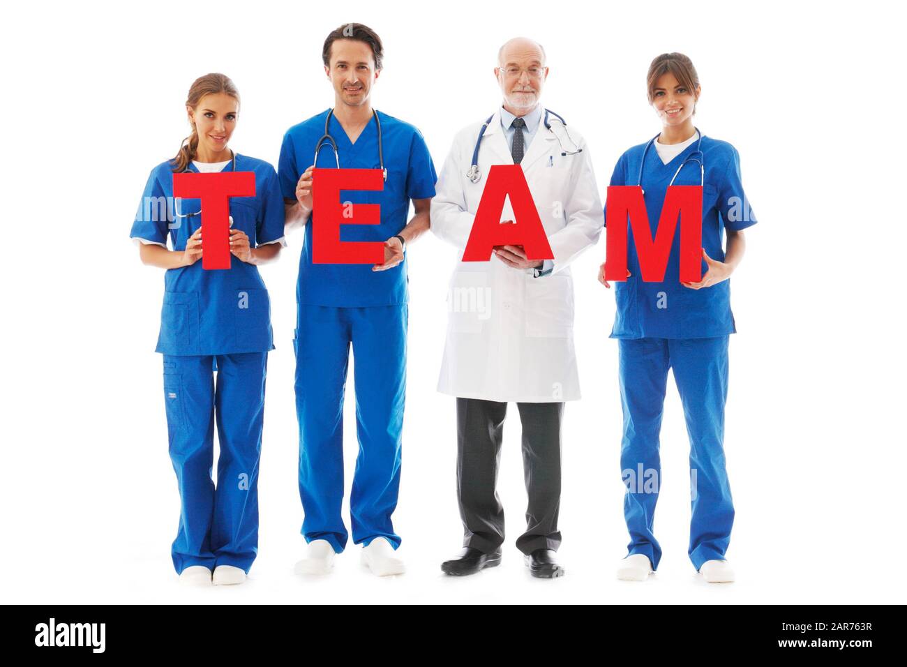 Doctors holding big red team letters isolated on white background Stock ...