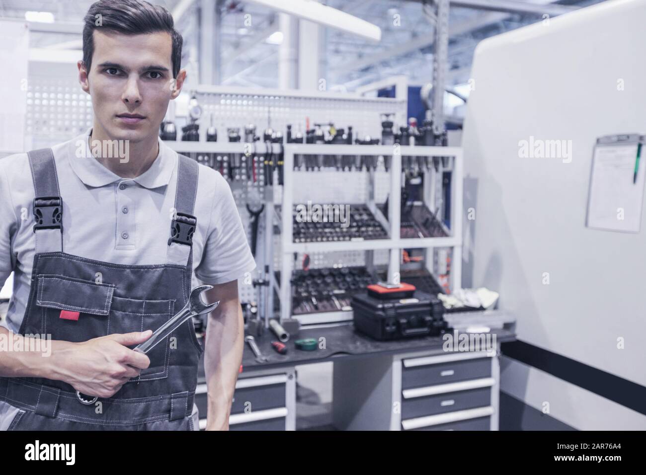 Mechanical technician worker at cnc milling plant workshop holding ...