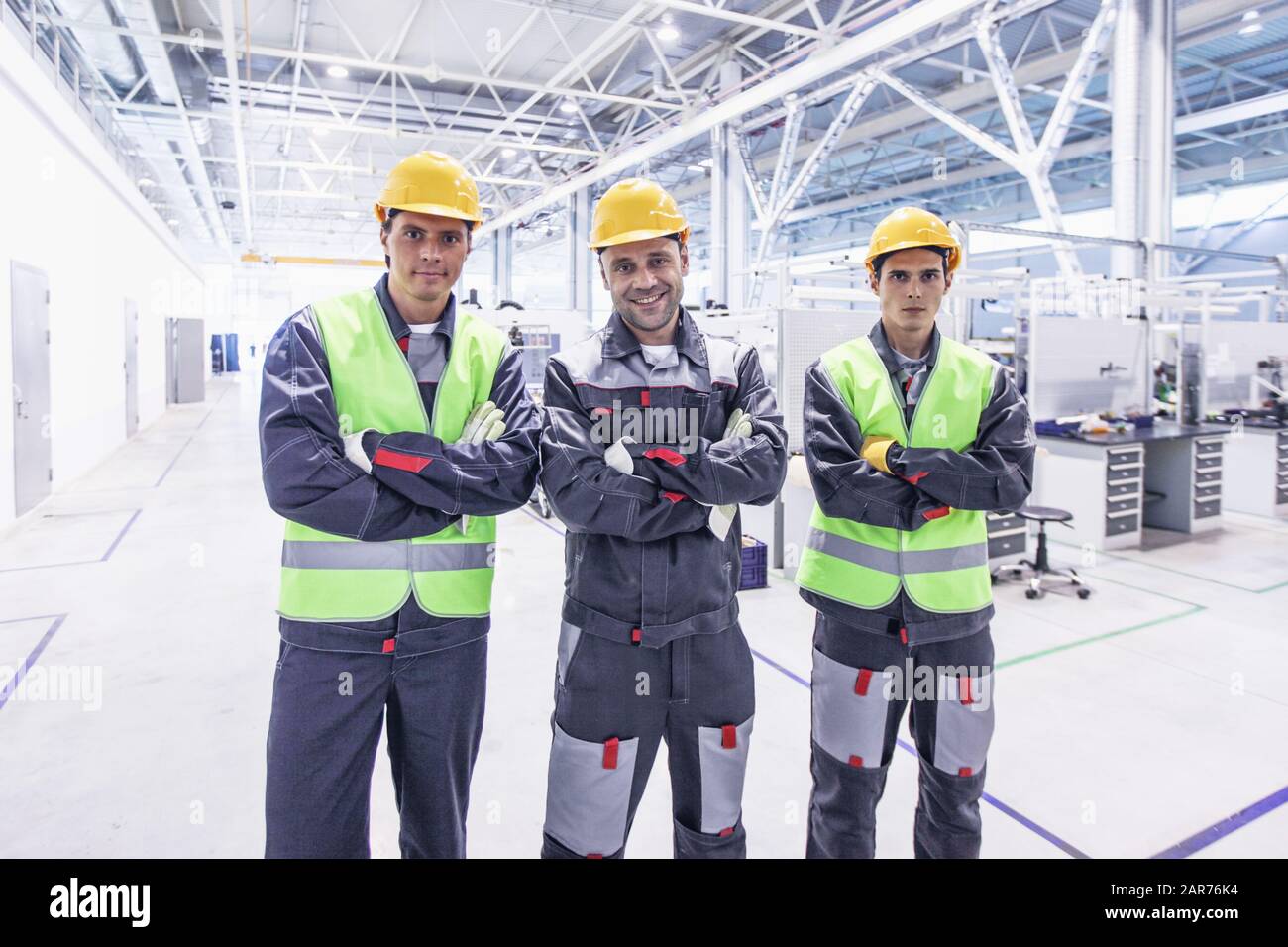 Portrait of three workers at factory teamwork cooperation concept Stock ...