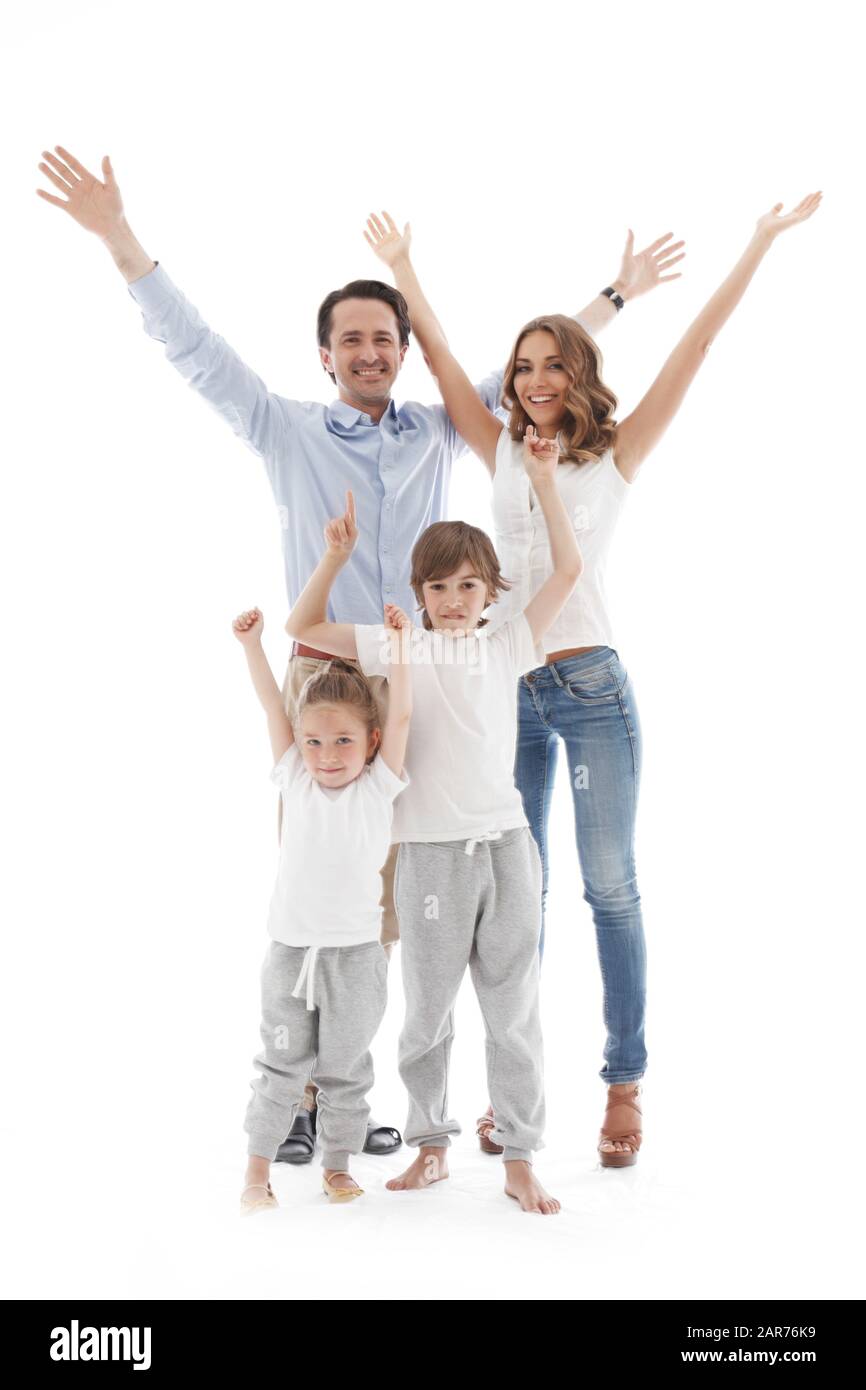 Happy smiling family of parents and two children with raised hands up ...