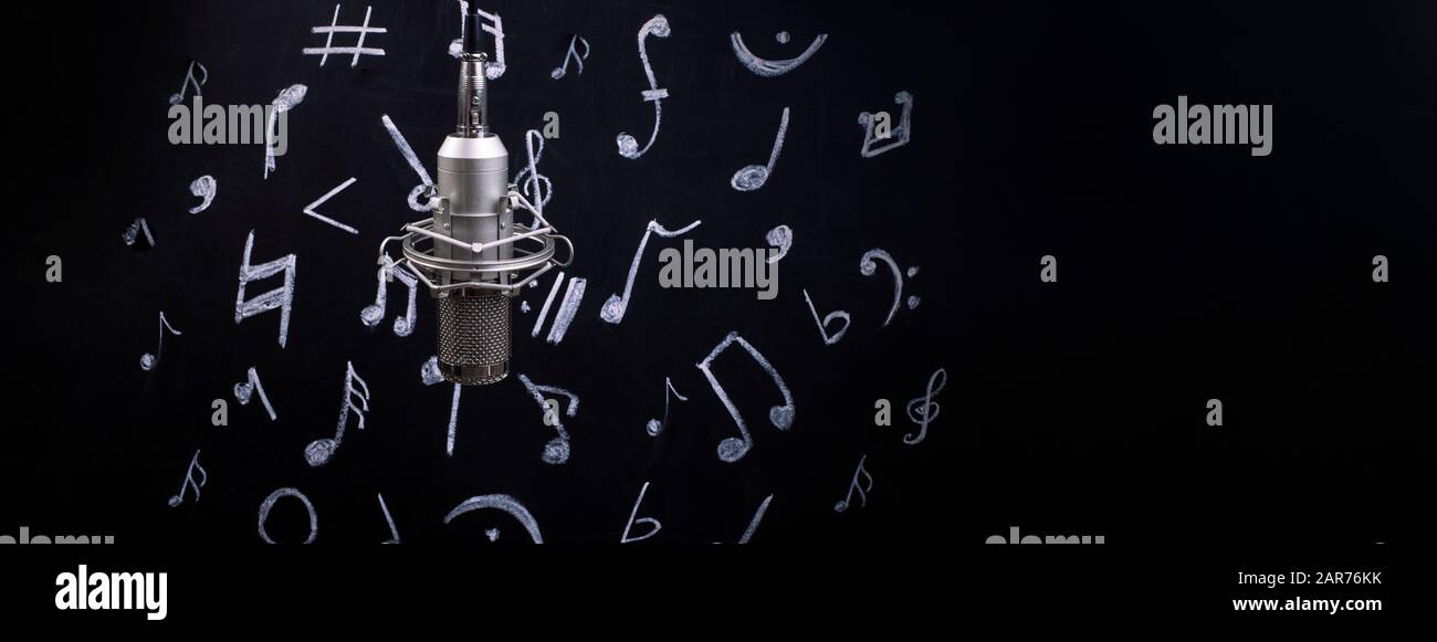 microphone on the background of the board for chalk with painted notes ...