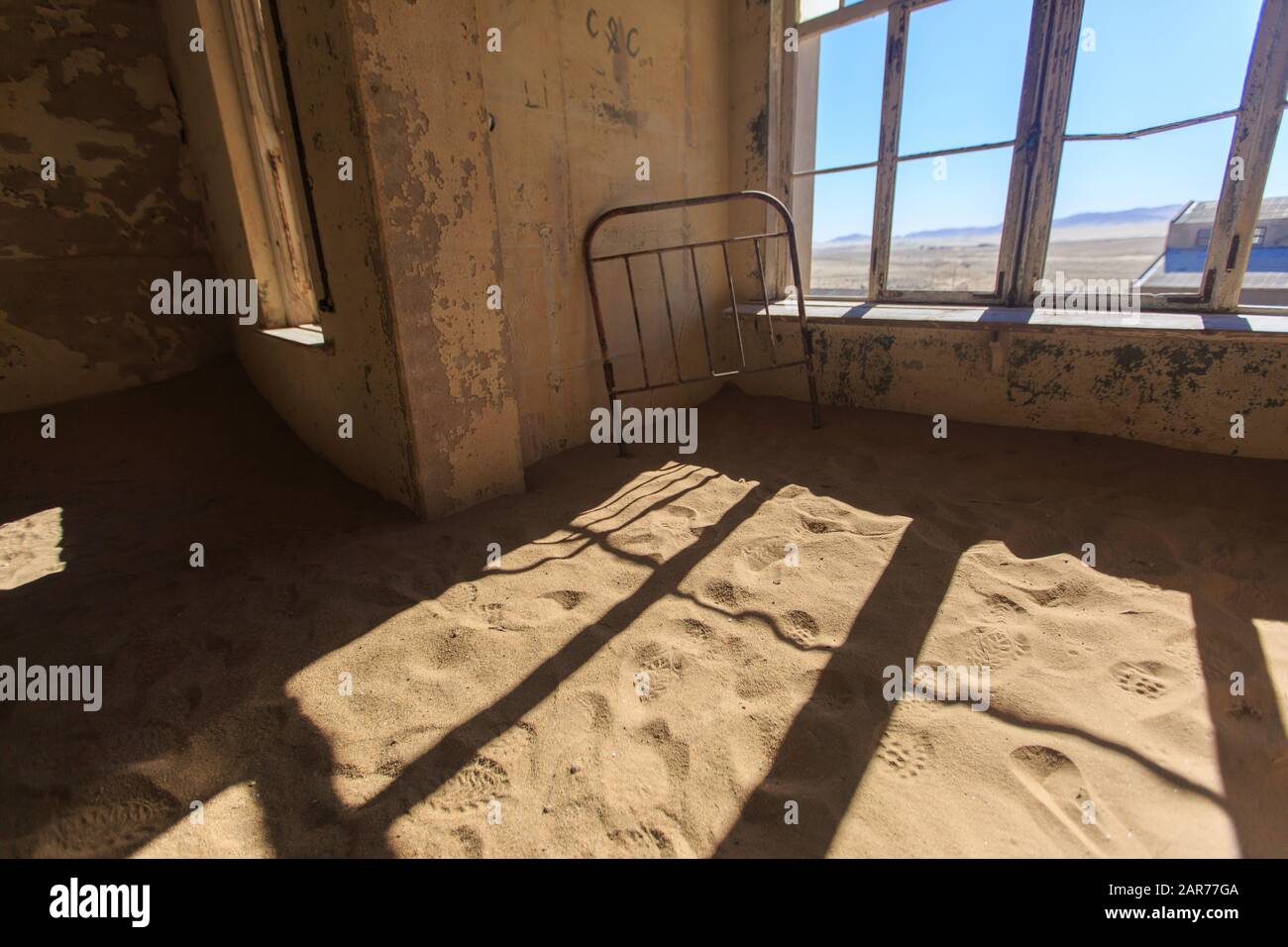Abandoned and forgotten building and room being taken over by encroaching sandstorm, Kolmanskop ...