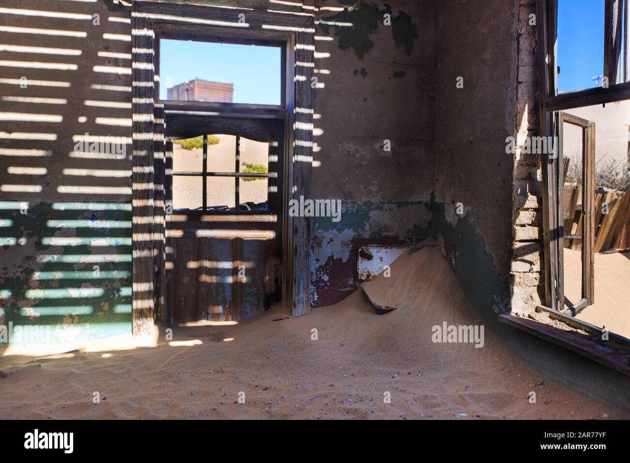 Abandoned and forgotten building and room being taken over by encroaching sandstorm, Kolmanskop ...