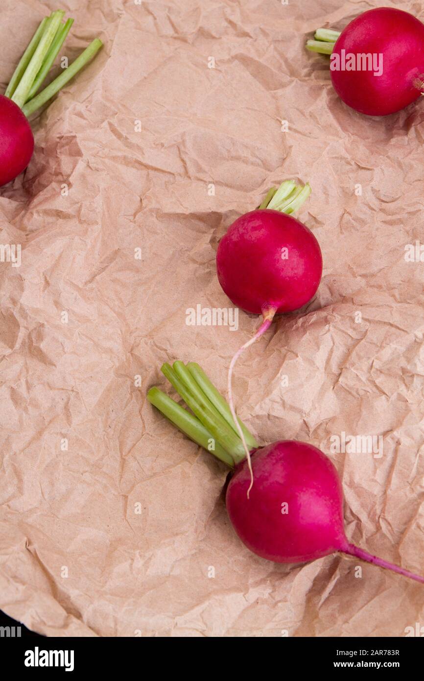 Red radishes on crumpled brown paper Stock Photo - Alamy