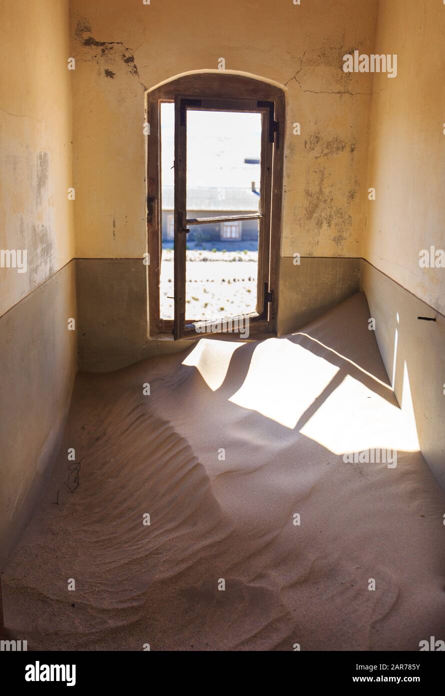 Abandoned and forgotten building and room being taken over by encroaching sandstorm, Kolmanskop ...
