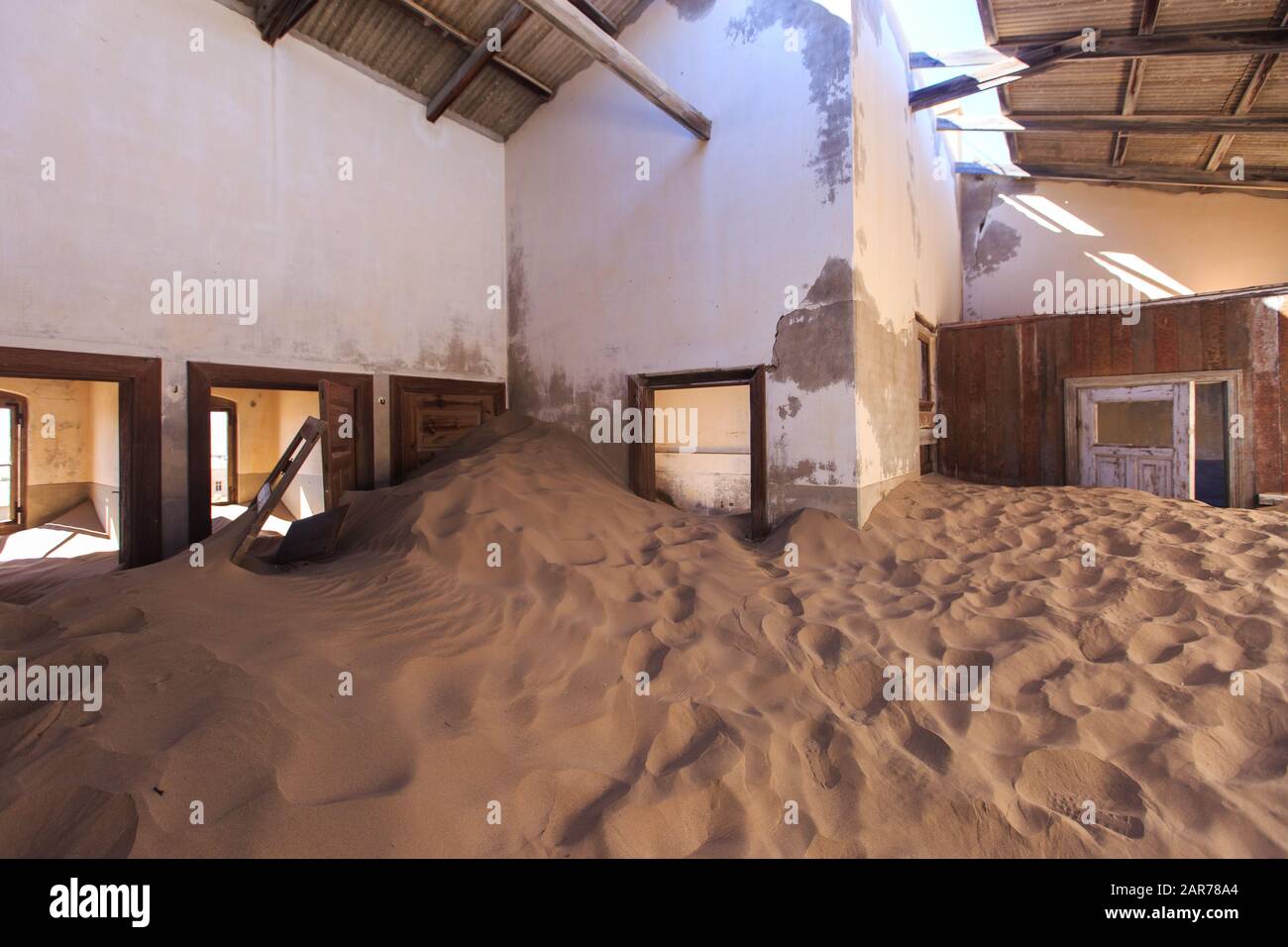 Abandoned and forgotten building and room being taken over by encroaching sandstorm, Kolmanskop ...