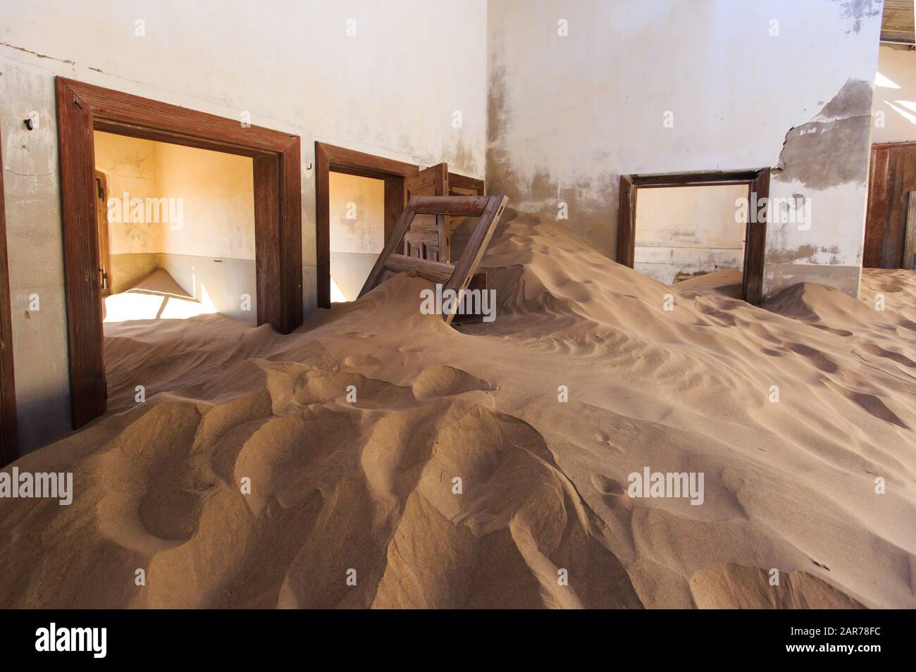 Abandoned and forgotten building and room being taken over by encroaching sandstorm, Kolmanskop ...