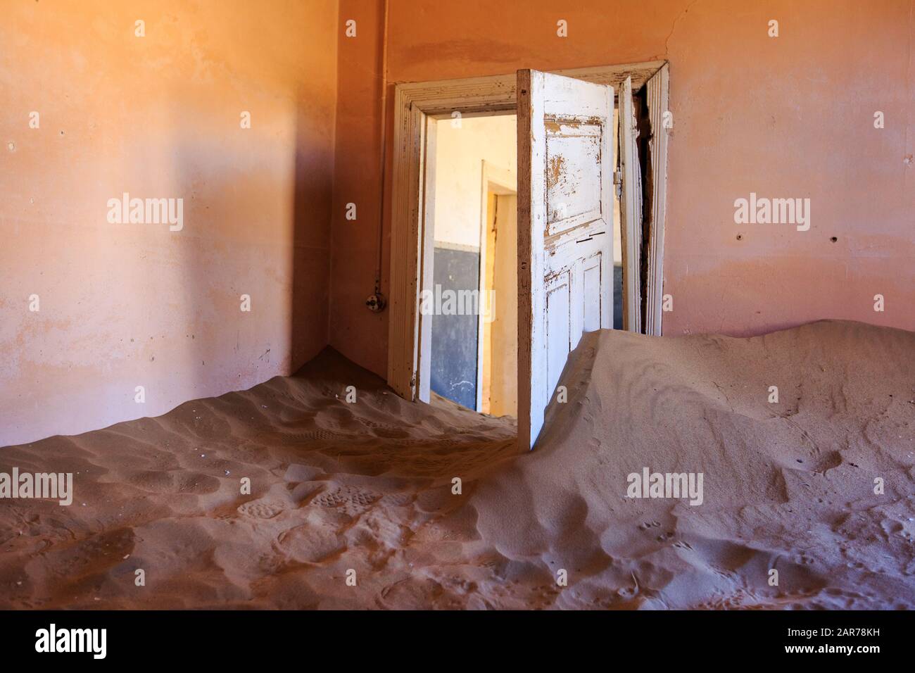 Abandoned and forgotten building and room being taken over by encroaching sandstorm, Kolmanskop ...