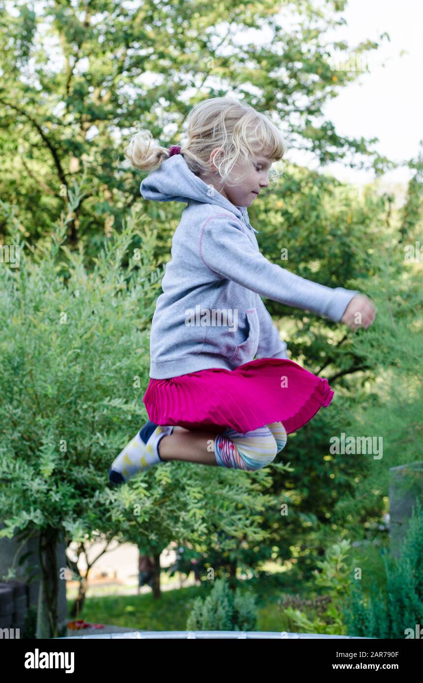 beautiful blond girl jumping image Stock Photo - Alamy