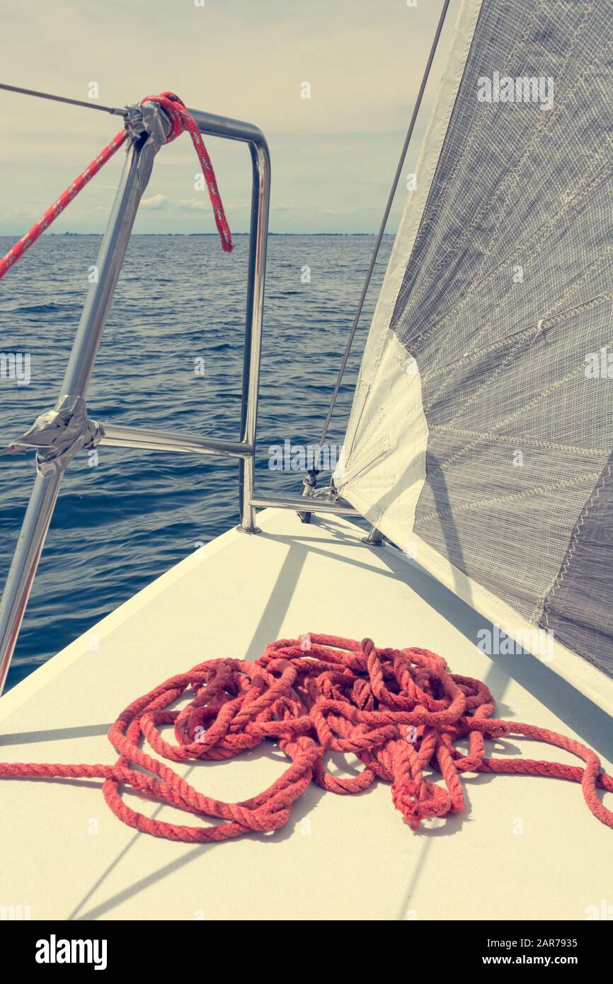 Sailboat deck with stacked red rope while sailing Stock Photo - Alamy