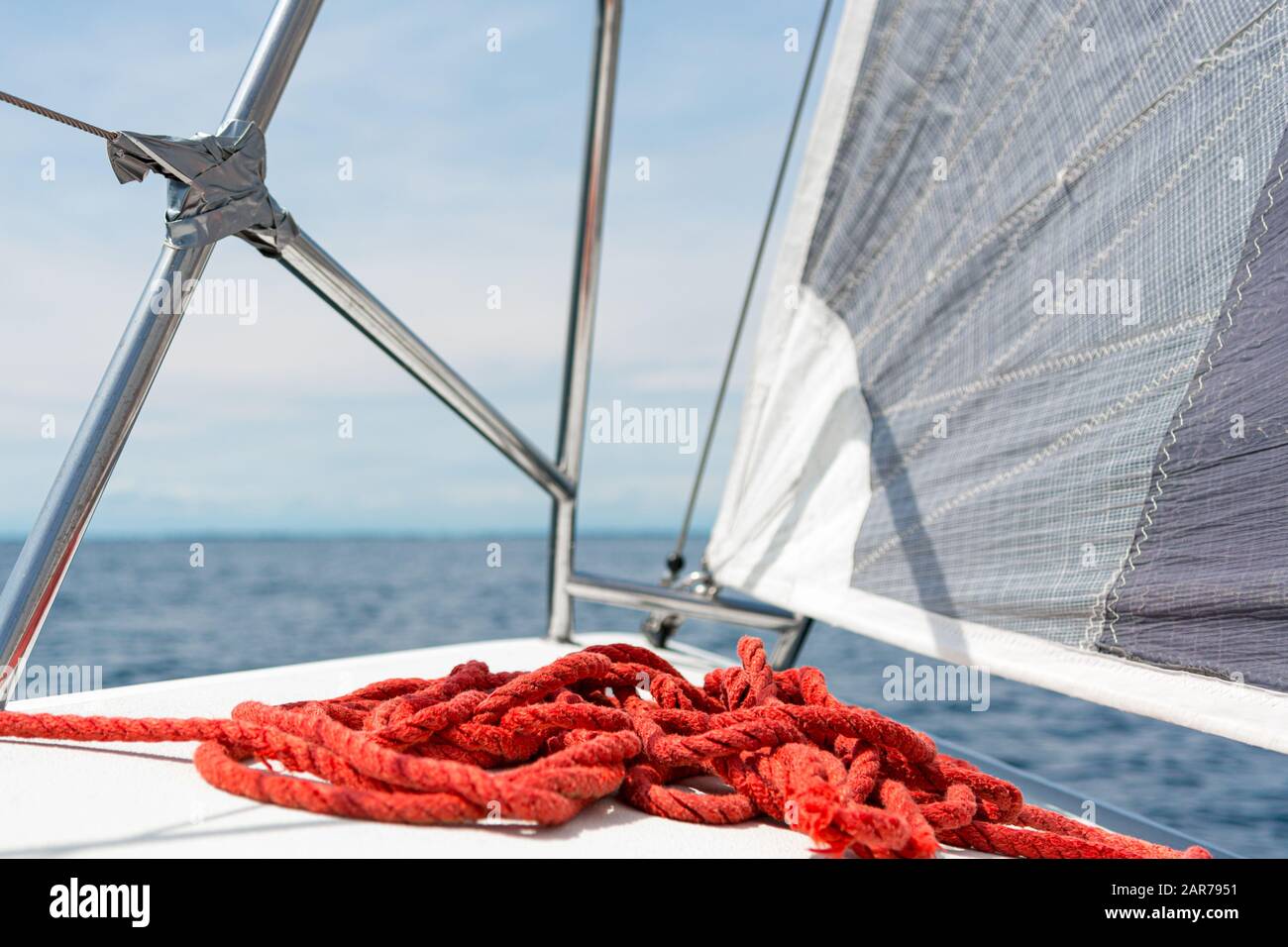 Sailboat deck with stacked red rope while sailing Stock Photo - Alamy