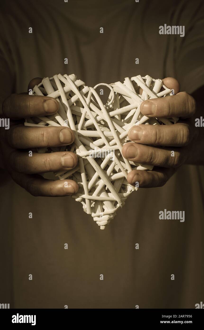 detail of white heart in hands Stock Photo - Alamy
