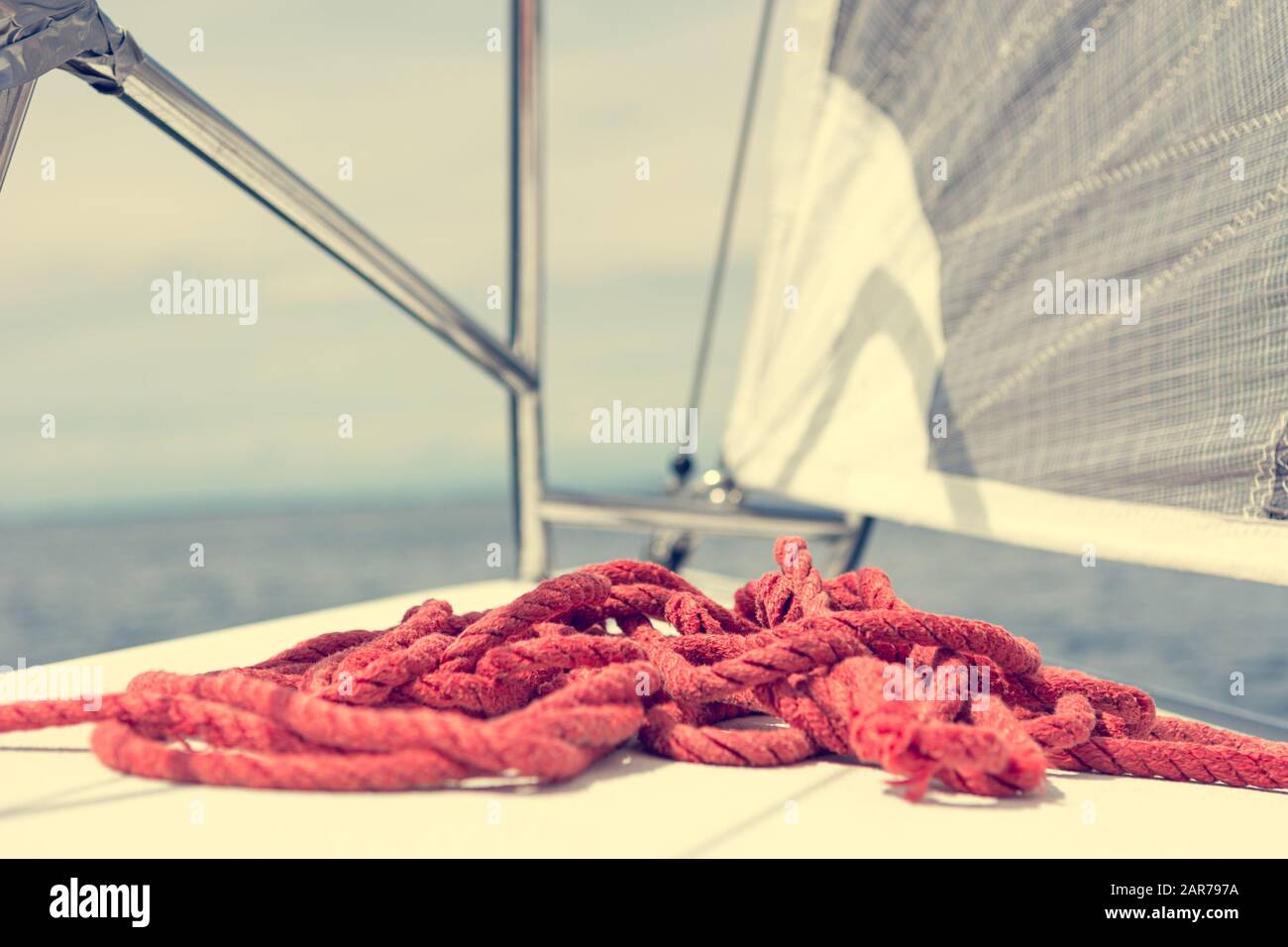 Sailboat deck with stacked red rope while sailing Stock Photo - Alamy