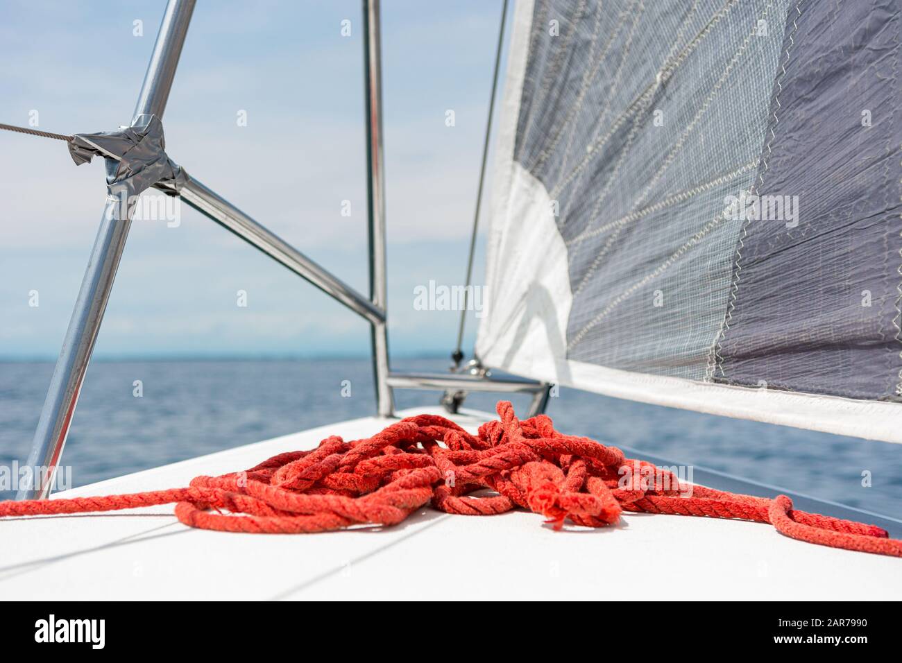 Sailboat deck with stacked red rope while sailing Stock Photo - Alamy