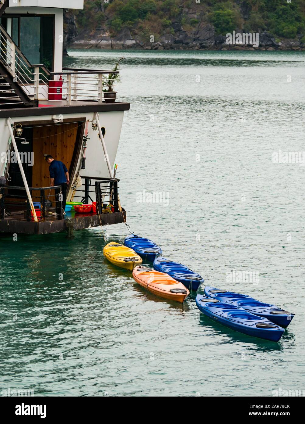 Tourist cruise ship pulling kayaks, Halong Bay, Vietnam, Asia Stock ...