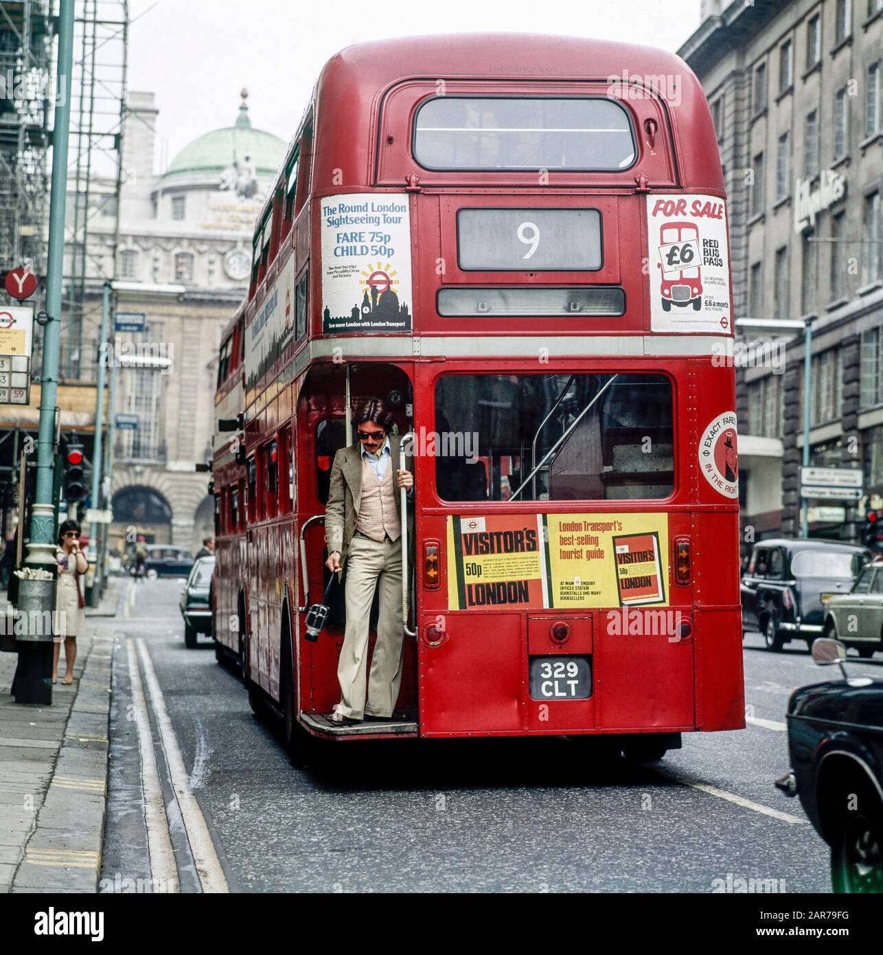 London 1970s, man with Hasselblad camera on rear platform of a red ...