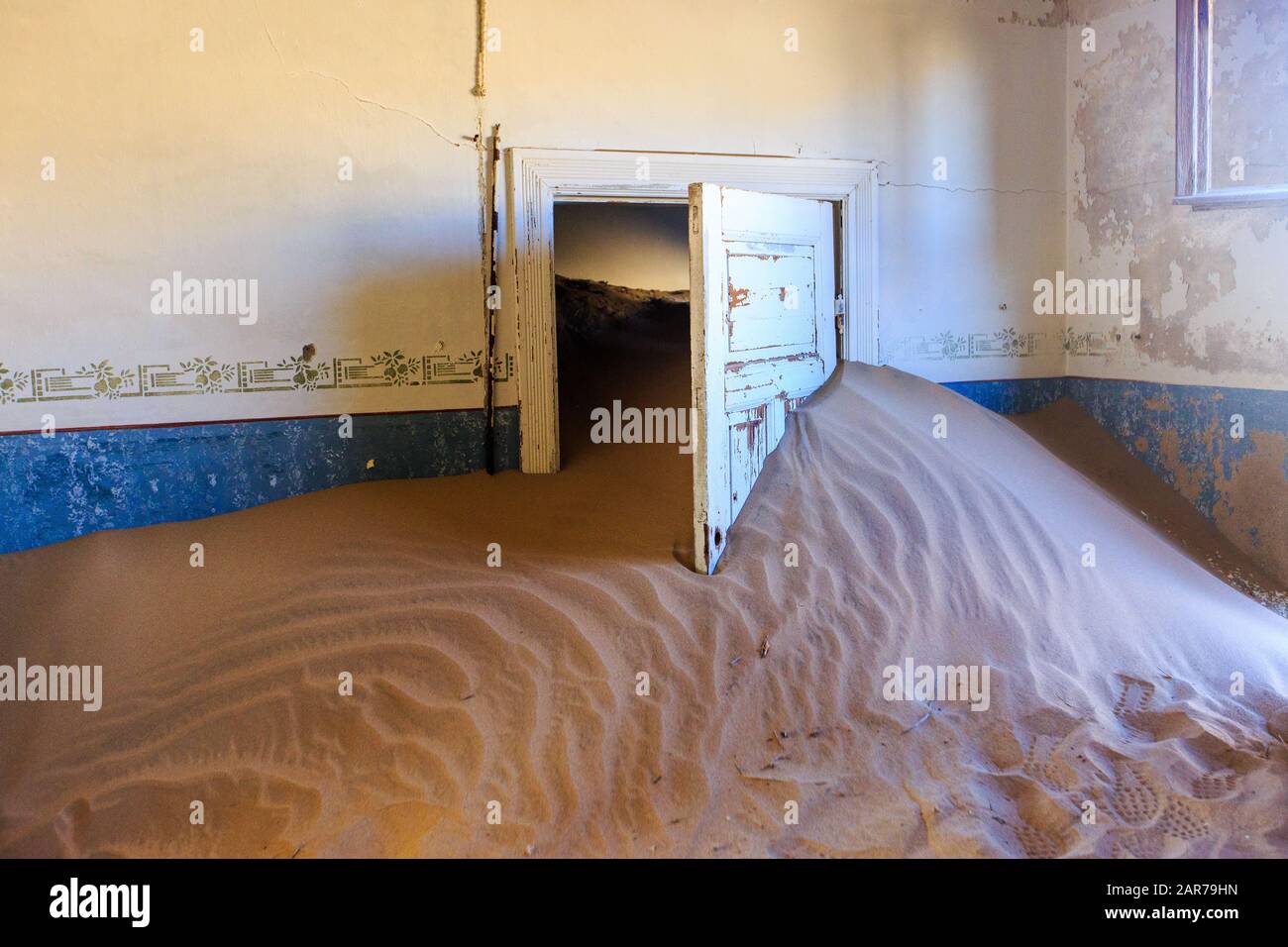 Abandoned and forgotten building and room being taken over by encroaching sandstorm, Kolmanskop ...