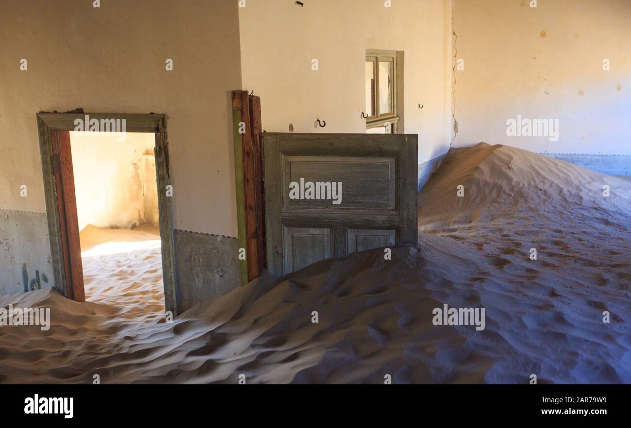 Abandoned and forgotten building and room being taken over by encroaching sandstorm, Kolmanskop ...