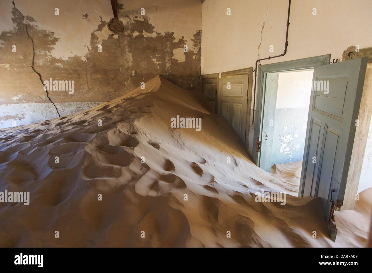 Abandoned and forgotten building and room being taken over by encroaching sandstorm, Kolmanskop ...