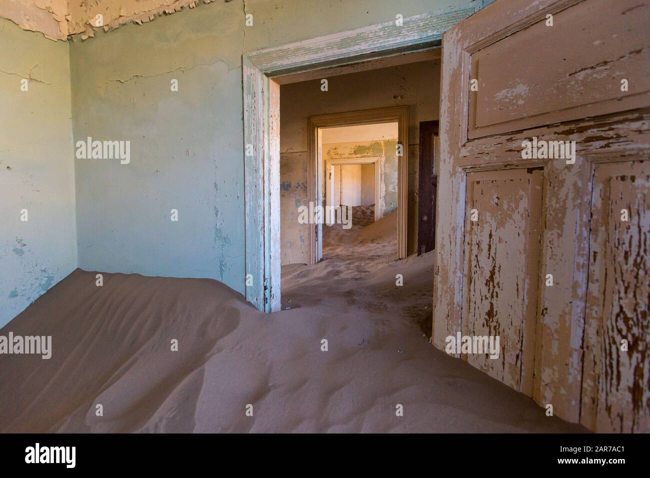 Abandoned and forgotten building and room being taken over by encroaching sandstorm, Kolmanskop ...