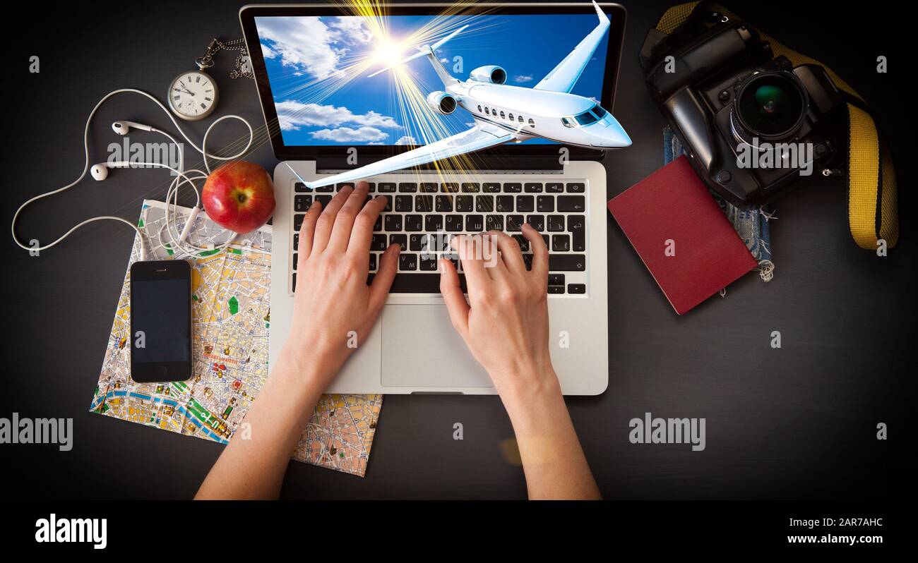 The plane fly out of the computer . Online travel booking concept Stock ...