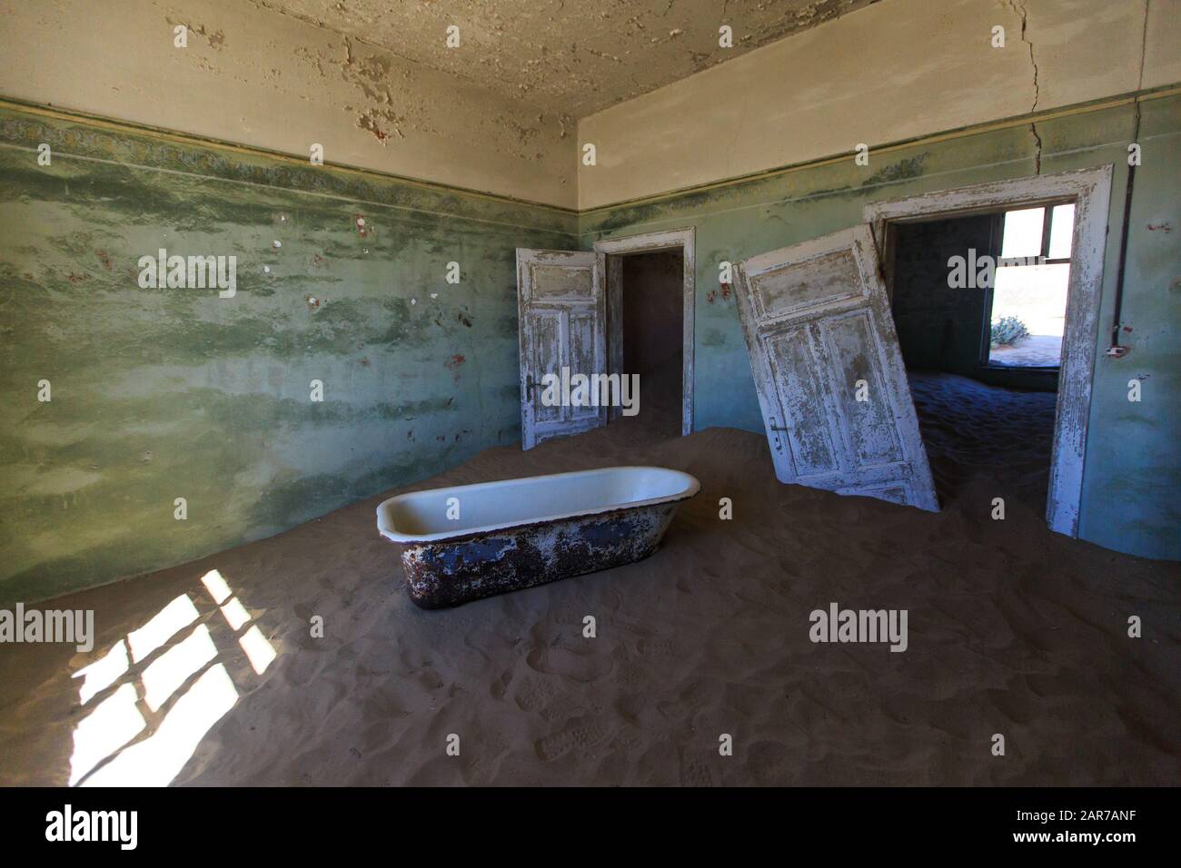 Abandoned and forgotten building and room being taken over by encroaching sandstorm, Kolmanskop ...