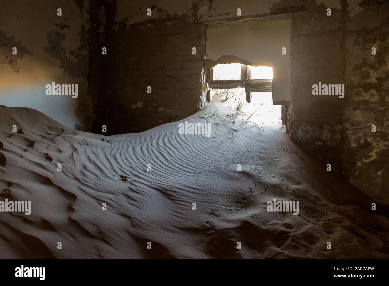 Abandoned and forgotten building and room being taken over by encroaching sandstorm, Kolmanskop ...
