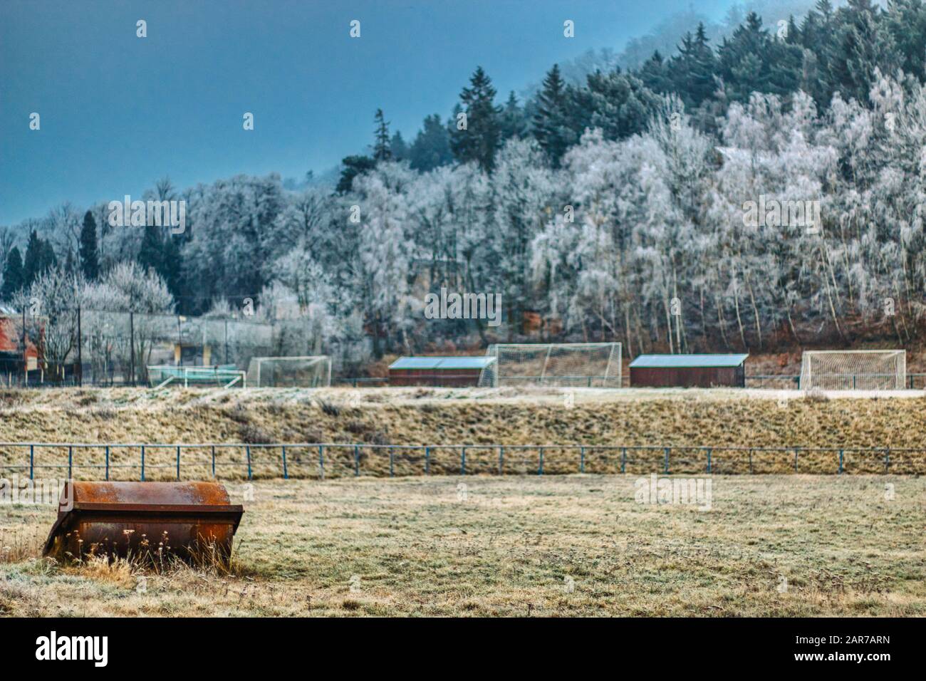 winter football field with frosted mountains in background and goals ...