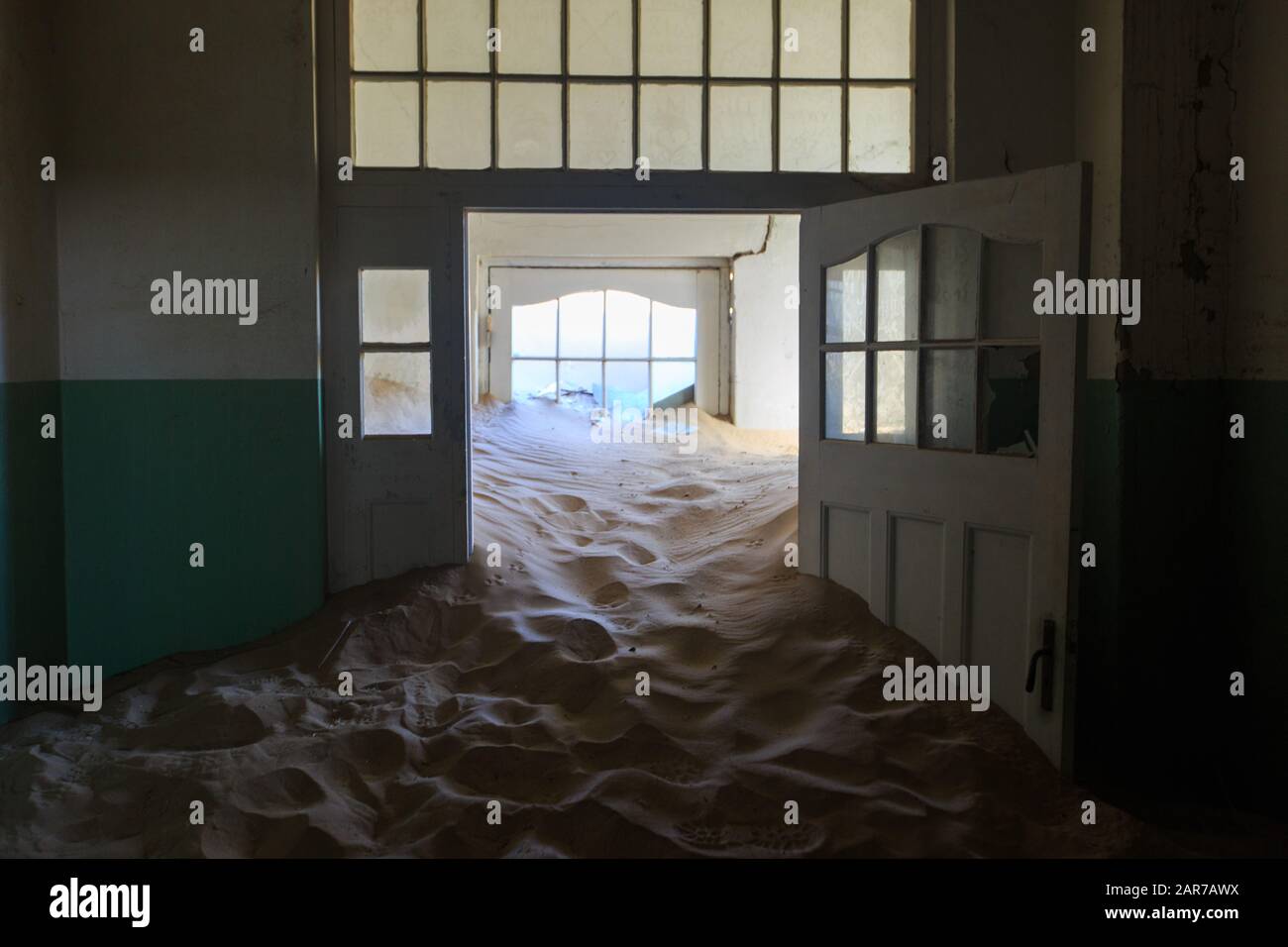 Abandoned and forgotten building and room being taken over by encroaching sandstorm, Kolmanskop ...
