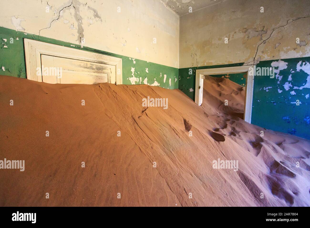Abandoned and forgotten building and room being taken over by encroaching sandstorm, Kolmanskop ...