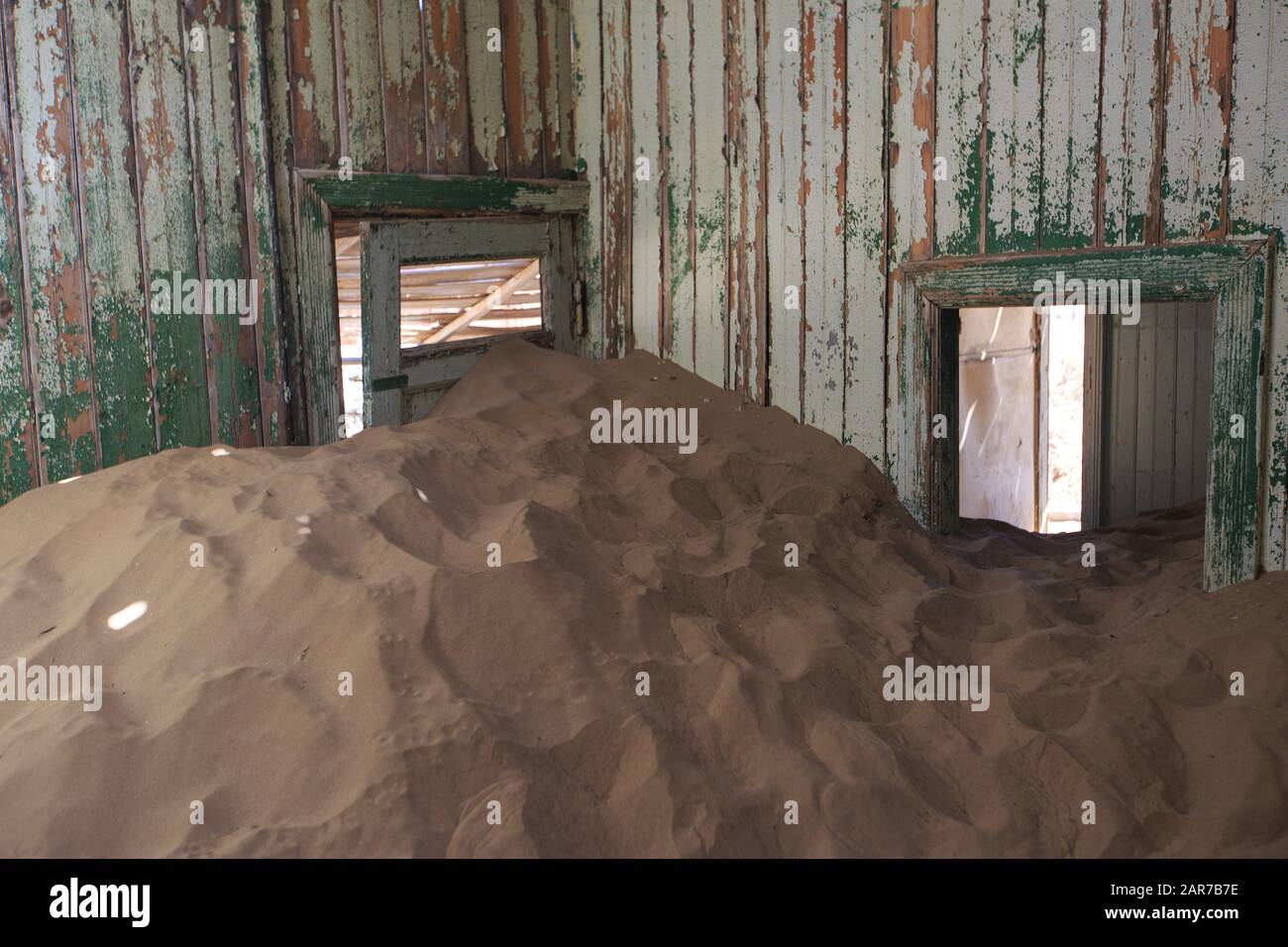 Abandoned and forgotten building and room being taken over by encroaching sandstorm, Kolmanskop ...