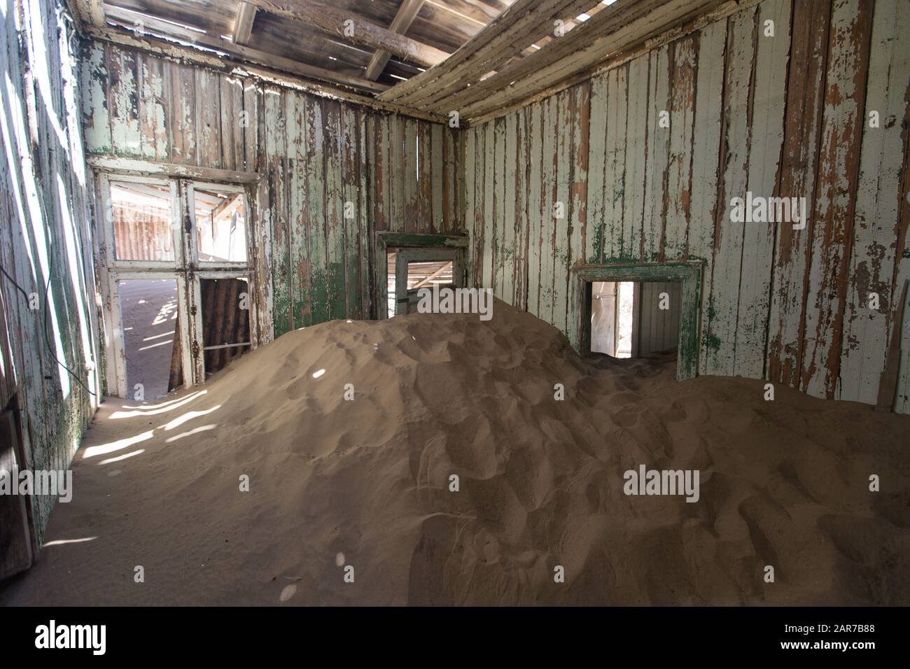 Abandoned and forgotten building and room being taken over by encroaching sandstorm, Kolmanskop ...