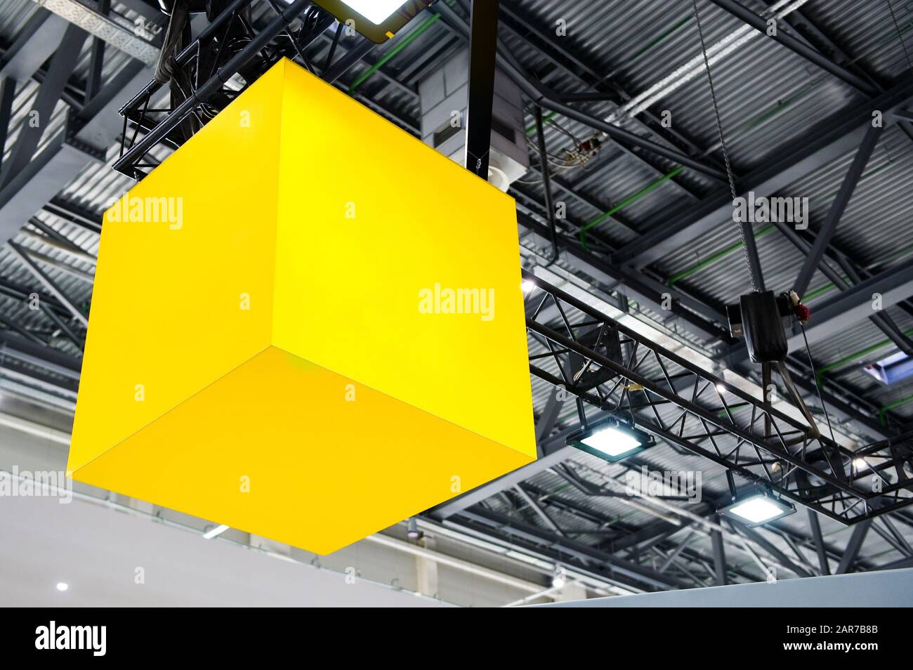 yellow glowing cube suspended under the roof of the hangar Stock Photo ...