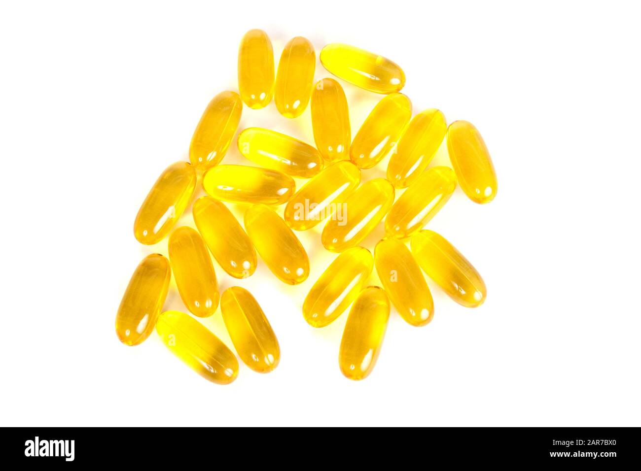 Yellow gel caps on a white background Stock Photo - Alamy