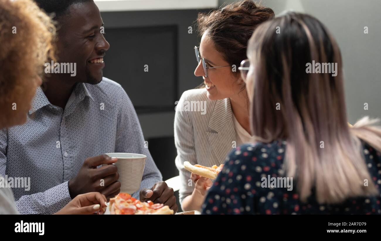 Happy Diverse Coworkers Have Fun Spending Lunch Break Together Stock