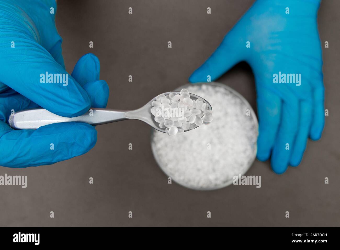 Plastic granules . Polyethylene pellets and hands with gloves. Quality ...