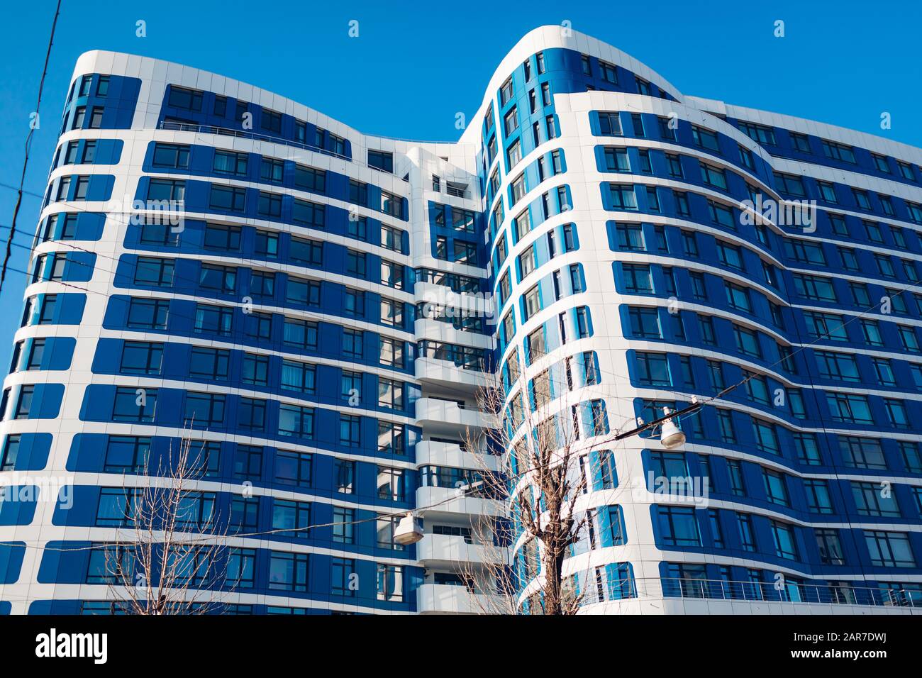 New multistorey residential round building. Modern house of blue and ...