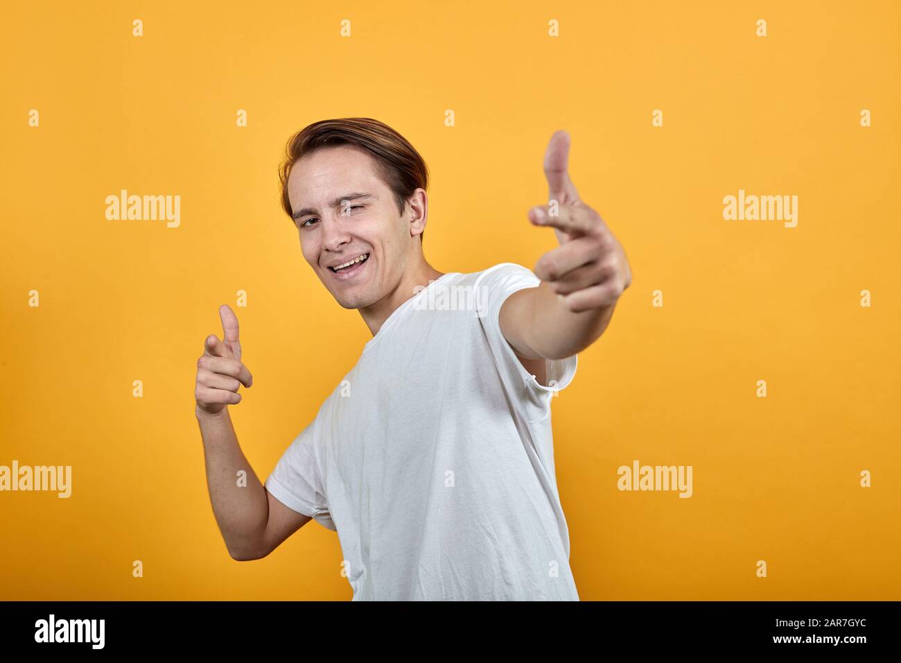 Attractive young man showing active gesture with his hands with a happy ...