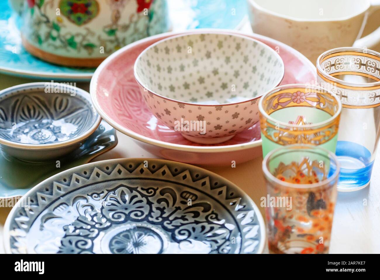 Collection of decorative tableware on the table Stock Photo - Alamy