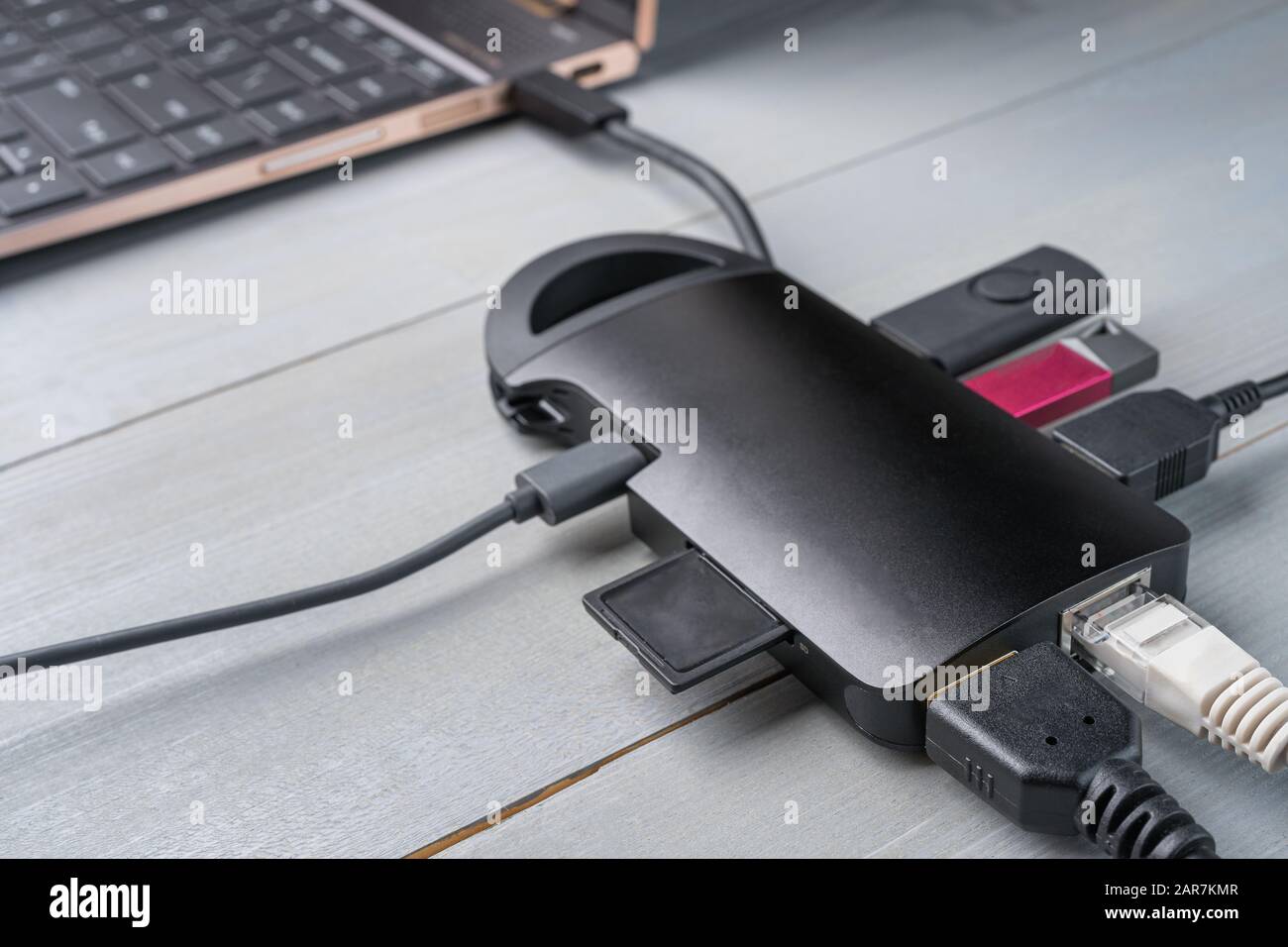 USB Type C adapter or hub connected to the laptop with various ...
