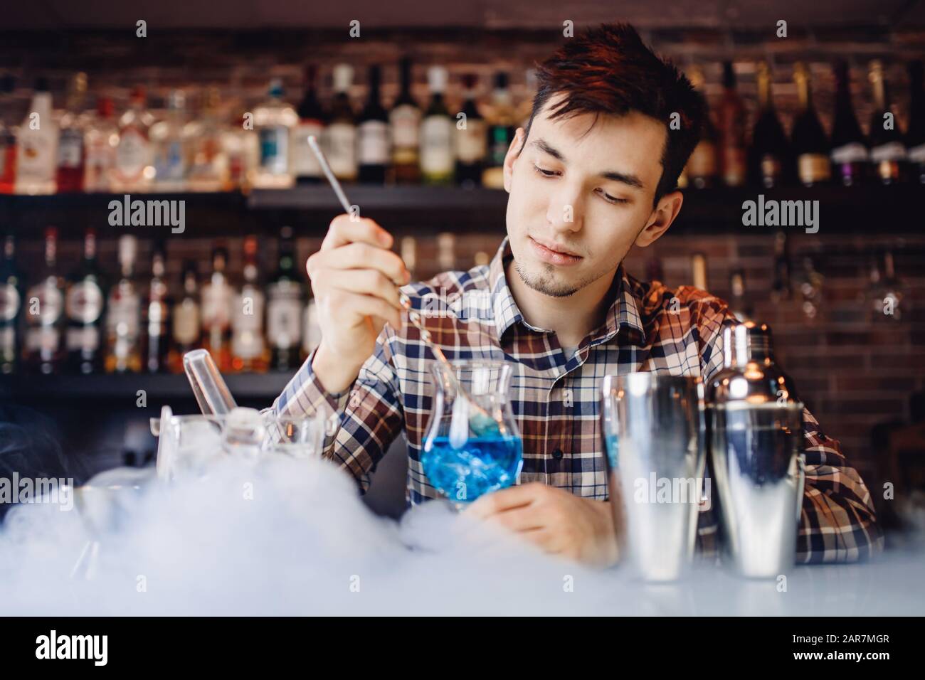 Barman mixes cocktail show with colorful alcoholic cocktails bar ...