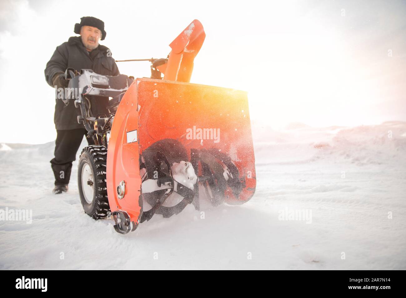 Man cleaning snow from sidewalks with snowblower machine winter Stock ...