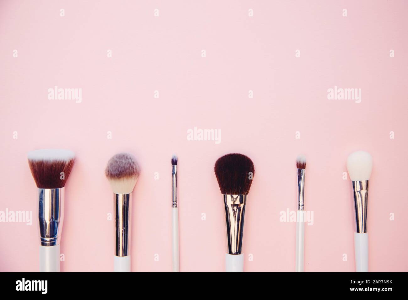 Set makeup brushes on pink color background. Top view point, flat lay ...