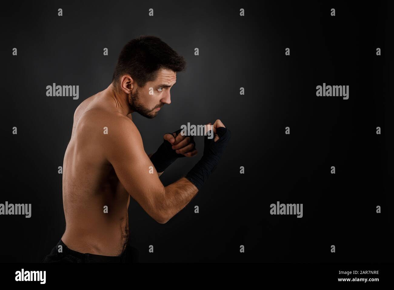 Sportsman boxer throwing a fierce and powerful punch. muscular man on ...