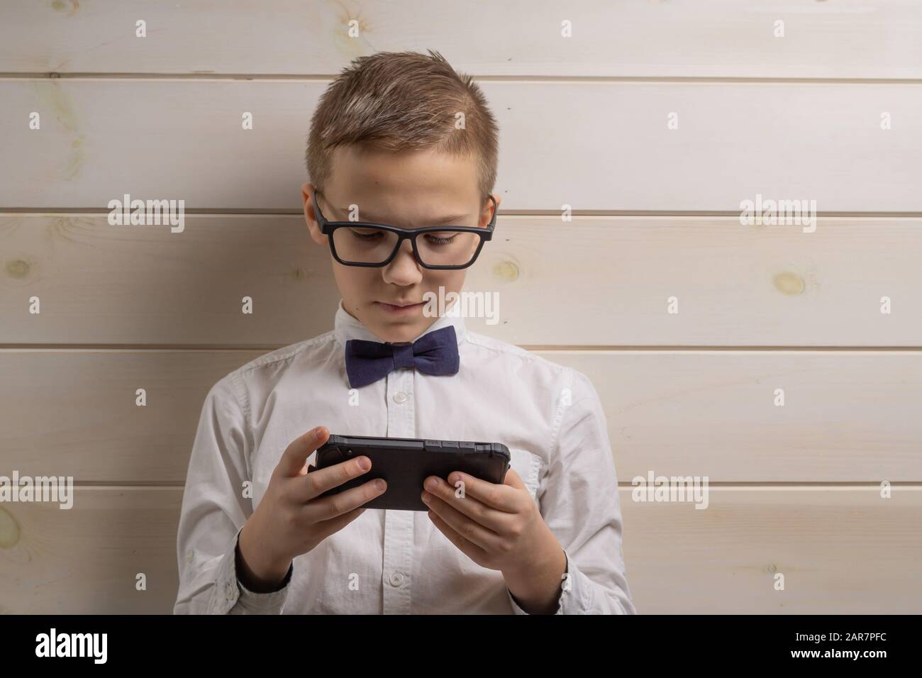 A fair-haired boy of 10 years in a white shirt with the self-tie bow ...
